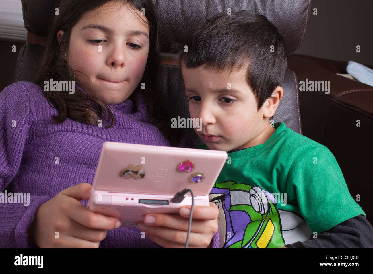 Siblings-children playing on a computer game Stock Photo - Alamy