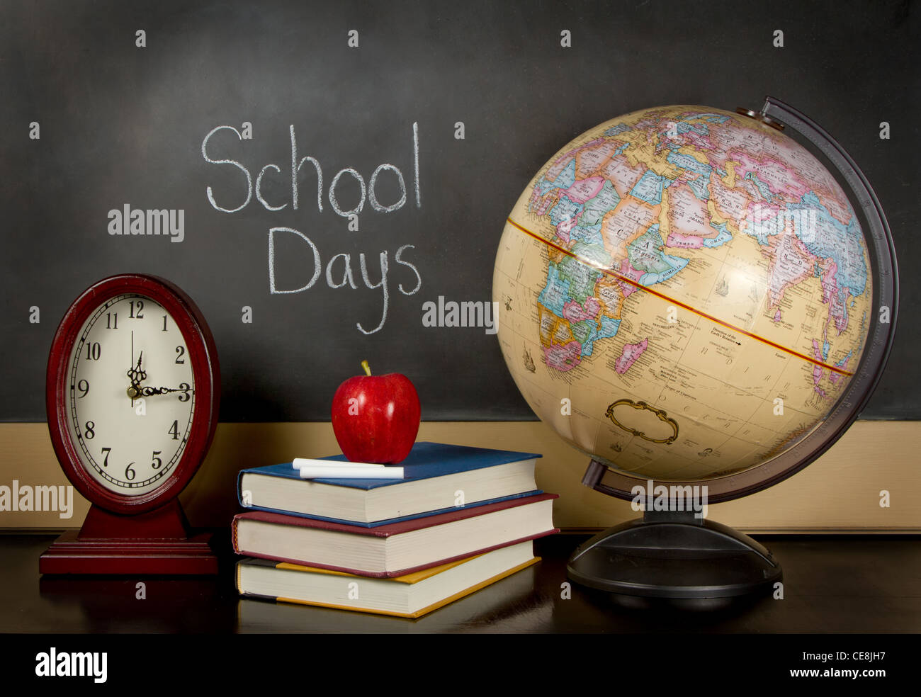 a chalkboard with the words school days written on it, a clock, books ...