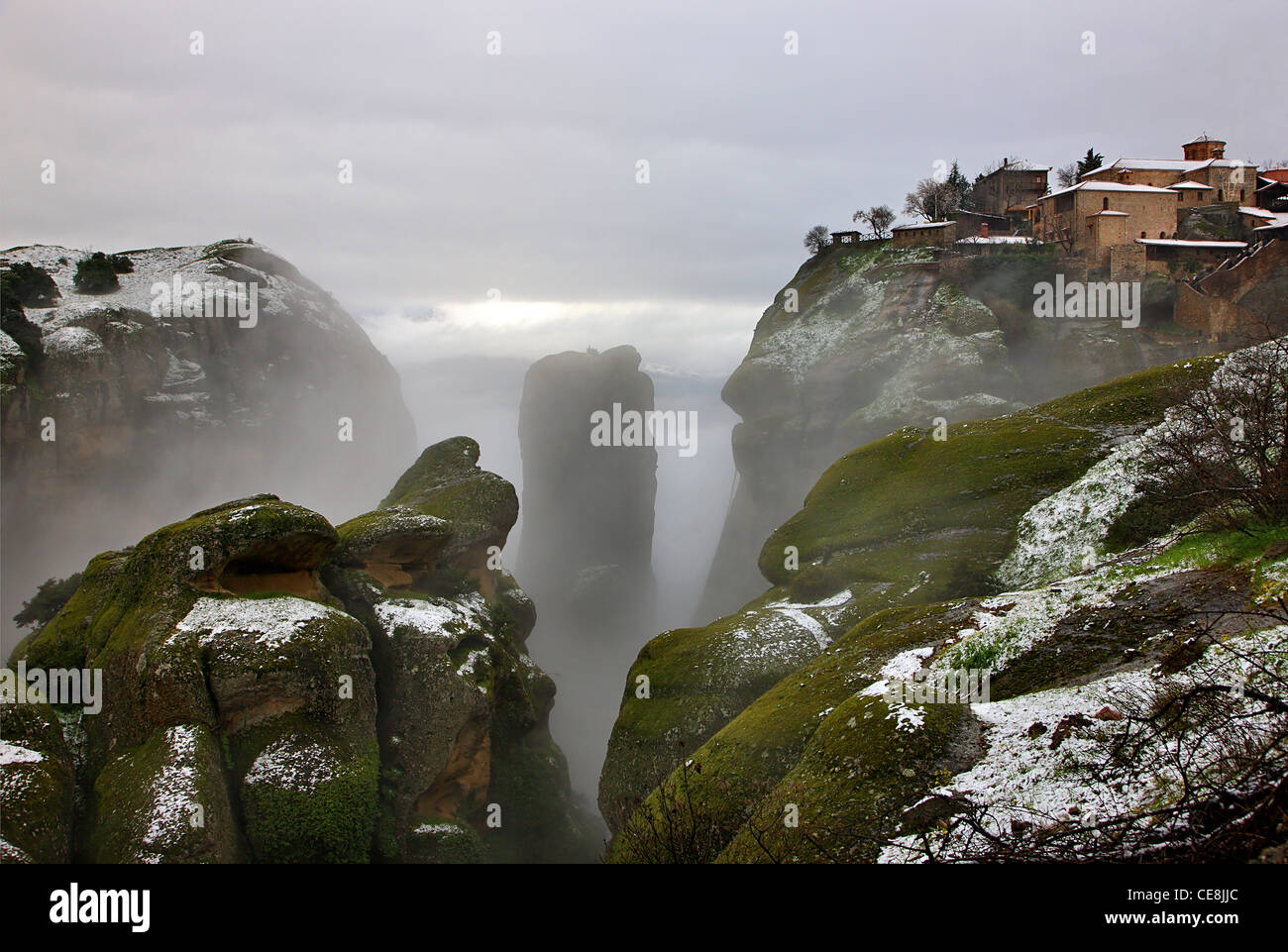 Greece, Meteora. Winter atmosphere with fog and snow. On the upper ...