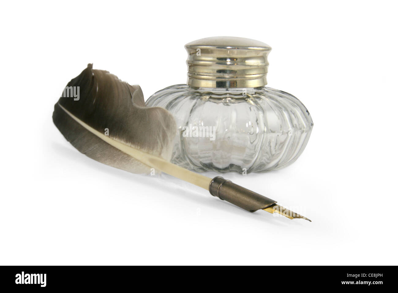 Feather quill pen in a circa 1890s to 1940s style glass inkwell Stock ...