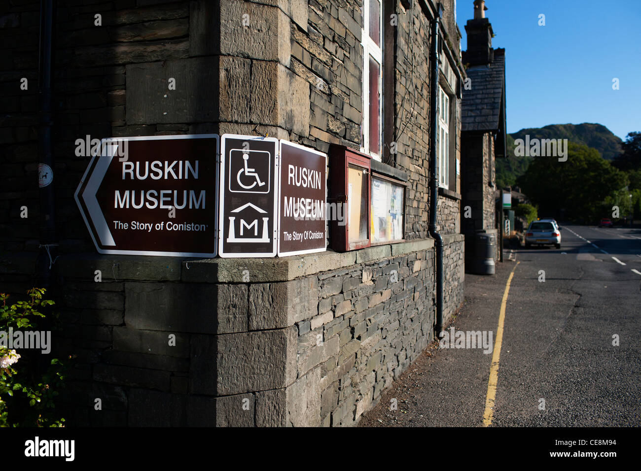 The sign points to the John Ruskin Museum in Coniston, Cumbria. There ...
