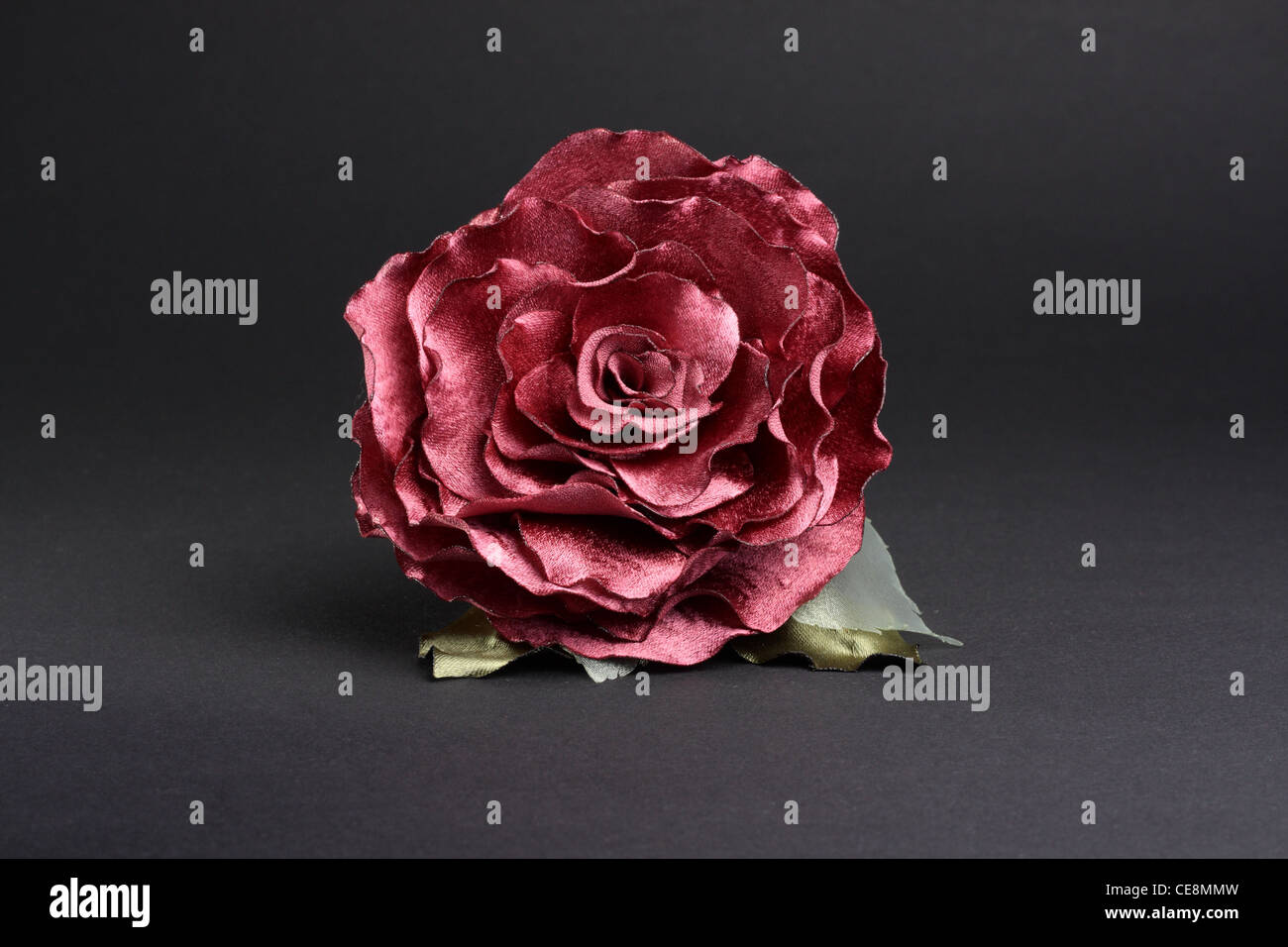 Artificial red rose at dark background Stock Photo - Alamy