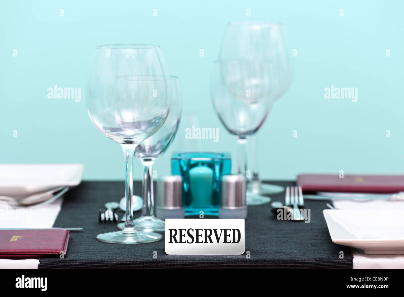 Photo of the reserved sign on a restaurant table setting. Focus is on ...