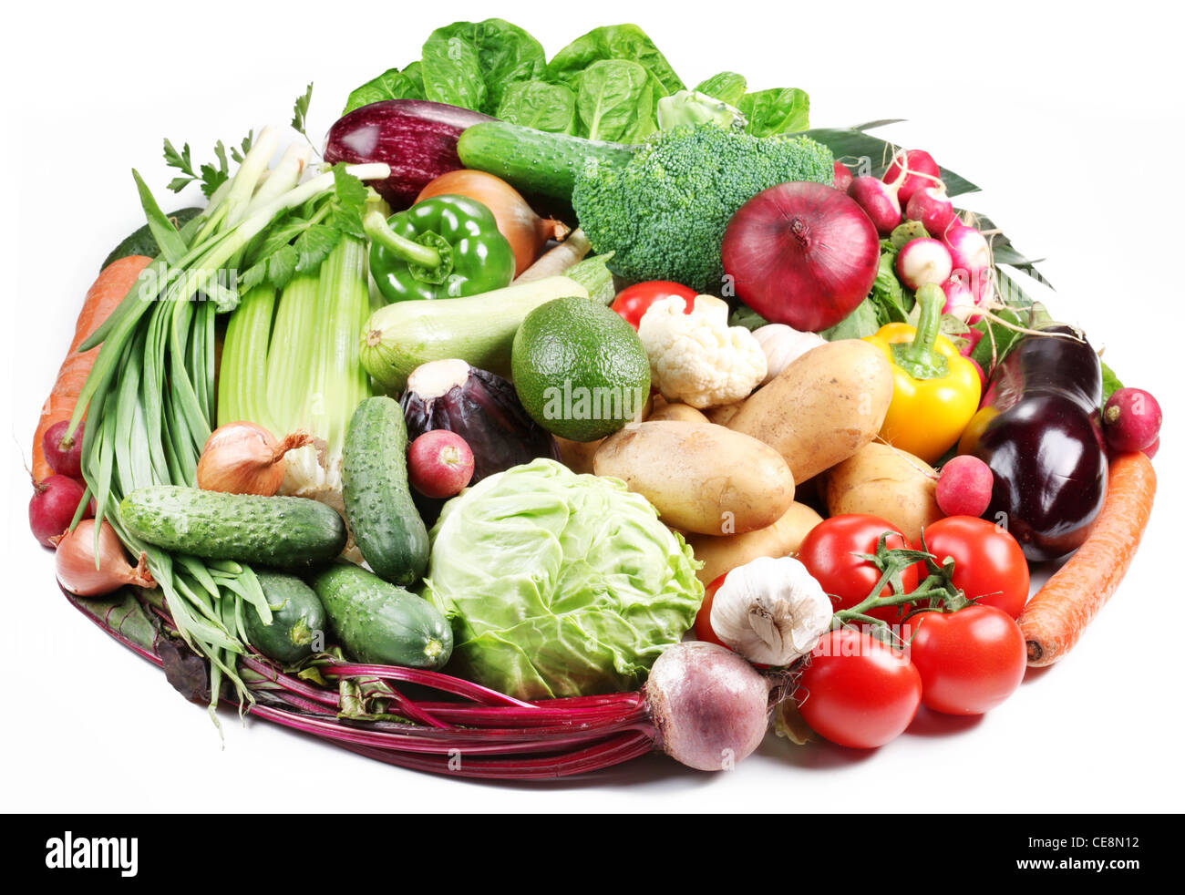 Variety of vegetables are laid out in a circle on a white background ...