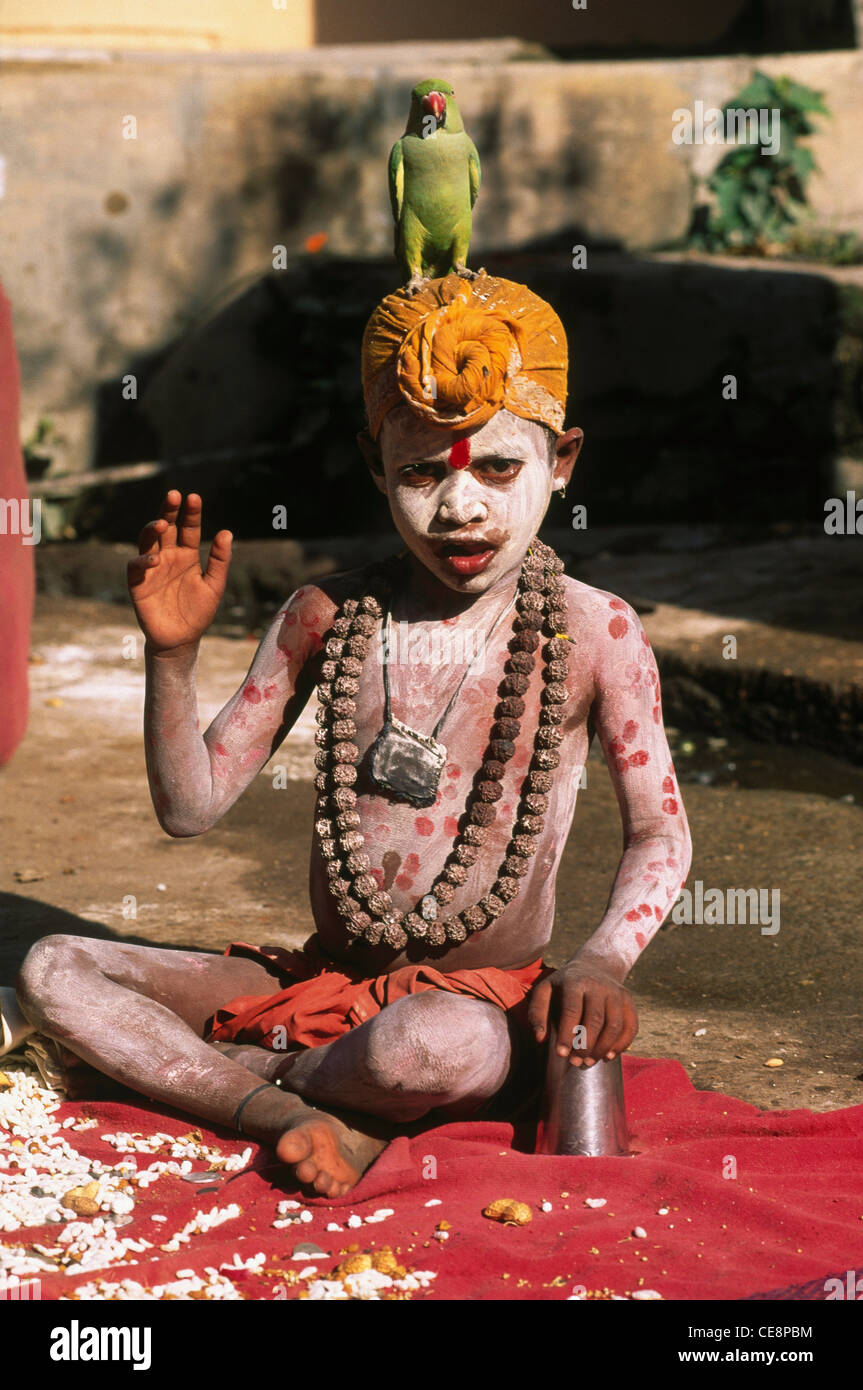 MMN 81180 : parrot sitting on child beggar posing as sadhu priest in ...