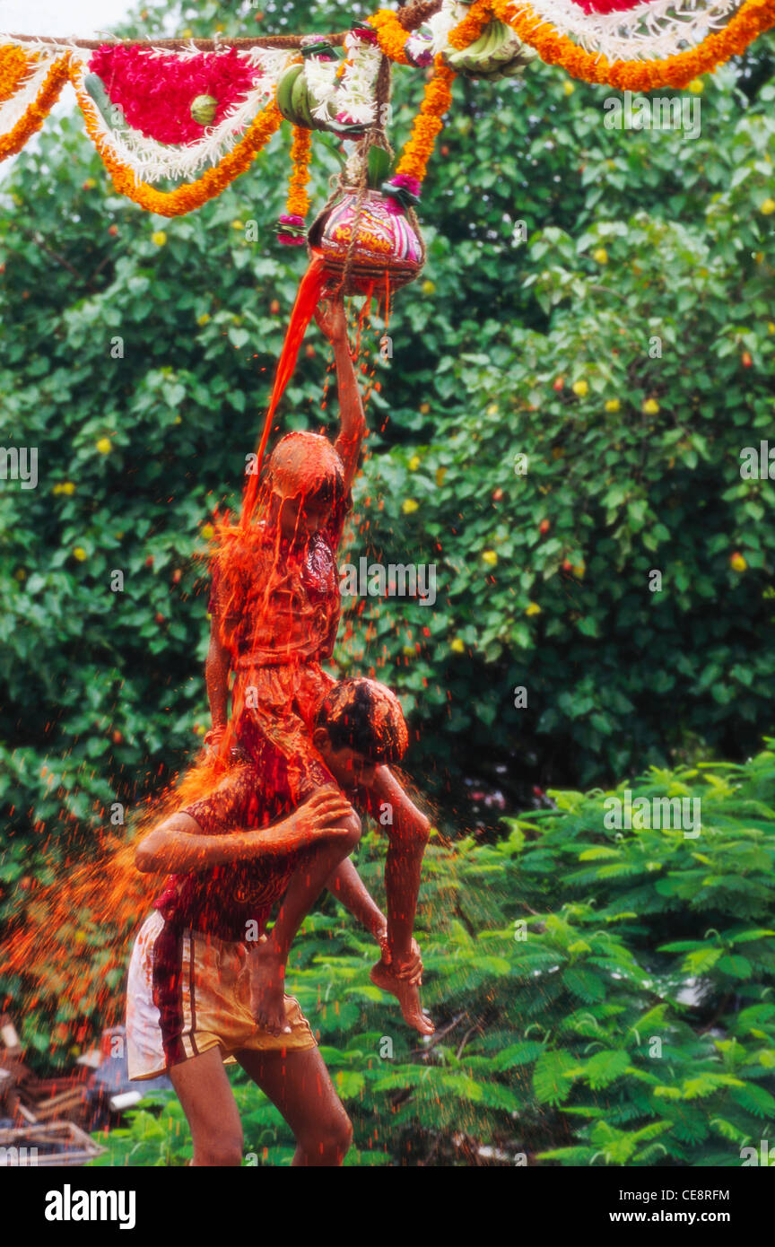 two boys drenched in coloured water after breaking pot on Janmashtami ...