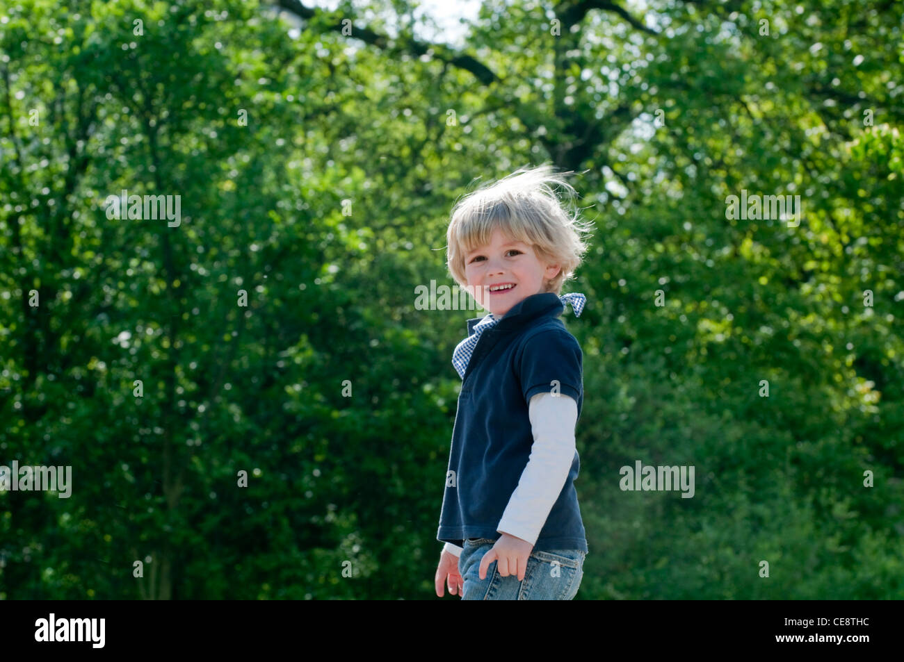 Blond boy playing outside Stock Photo - Alamy