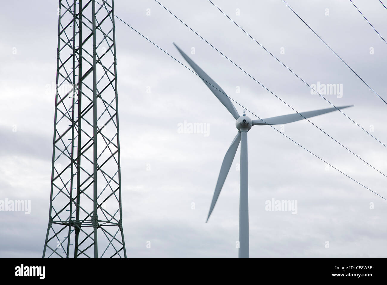 Windmill and overhead line tower Stock Photo - Alamy