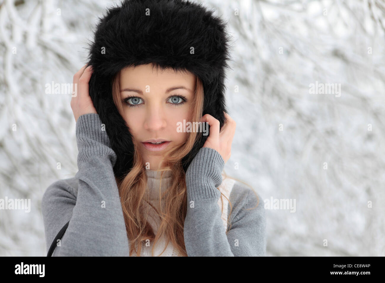 Young woman cap in snow Stock Photo - Alamy