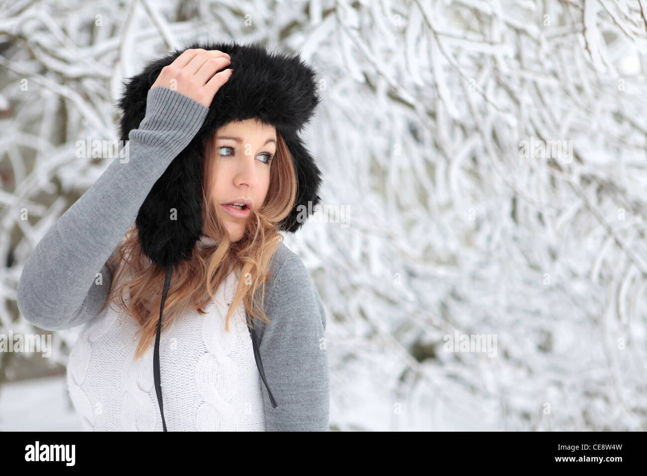 Young woman cap in snow Stock Photo - Alamy