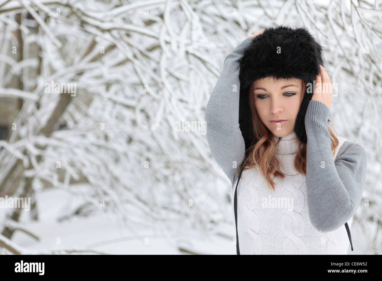 Young woman cap in snow Stock Photo - Alamy