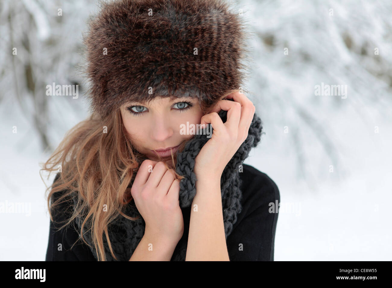 Young woman scarf and cap in snow Stock Photo - Alamy