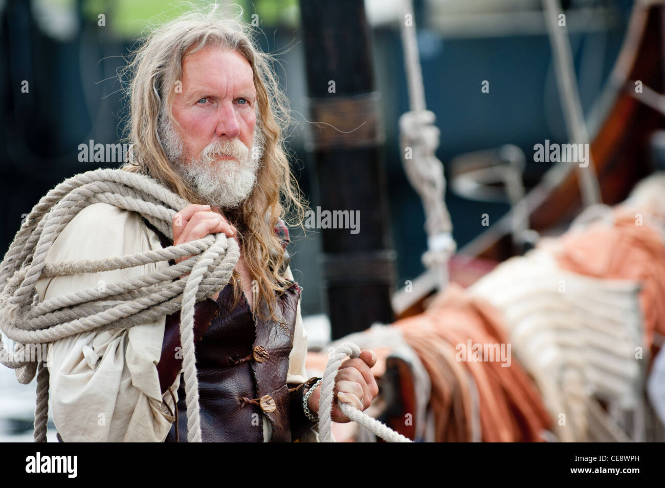 Strong man holding rope on boat on caledonian canal Stock Photo - Alamy