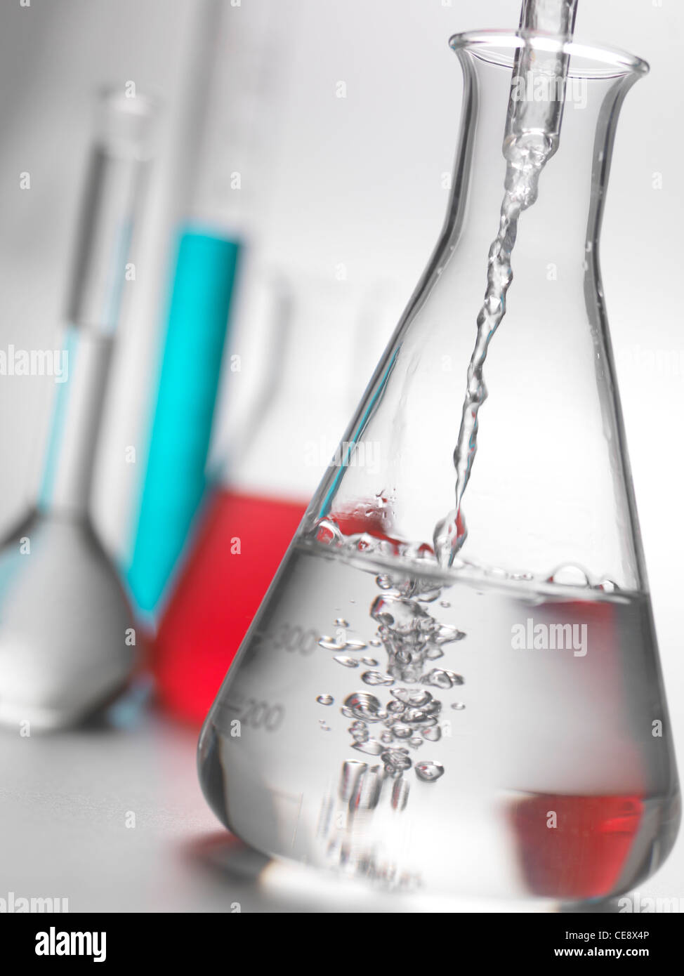 Laboratory glassware. Fluid being poured into a conical flask Stock ...