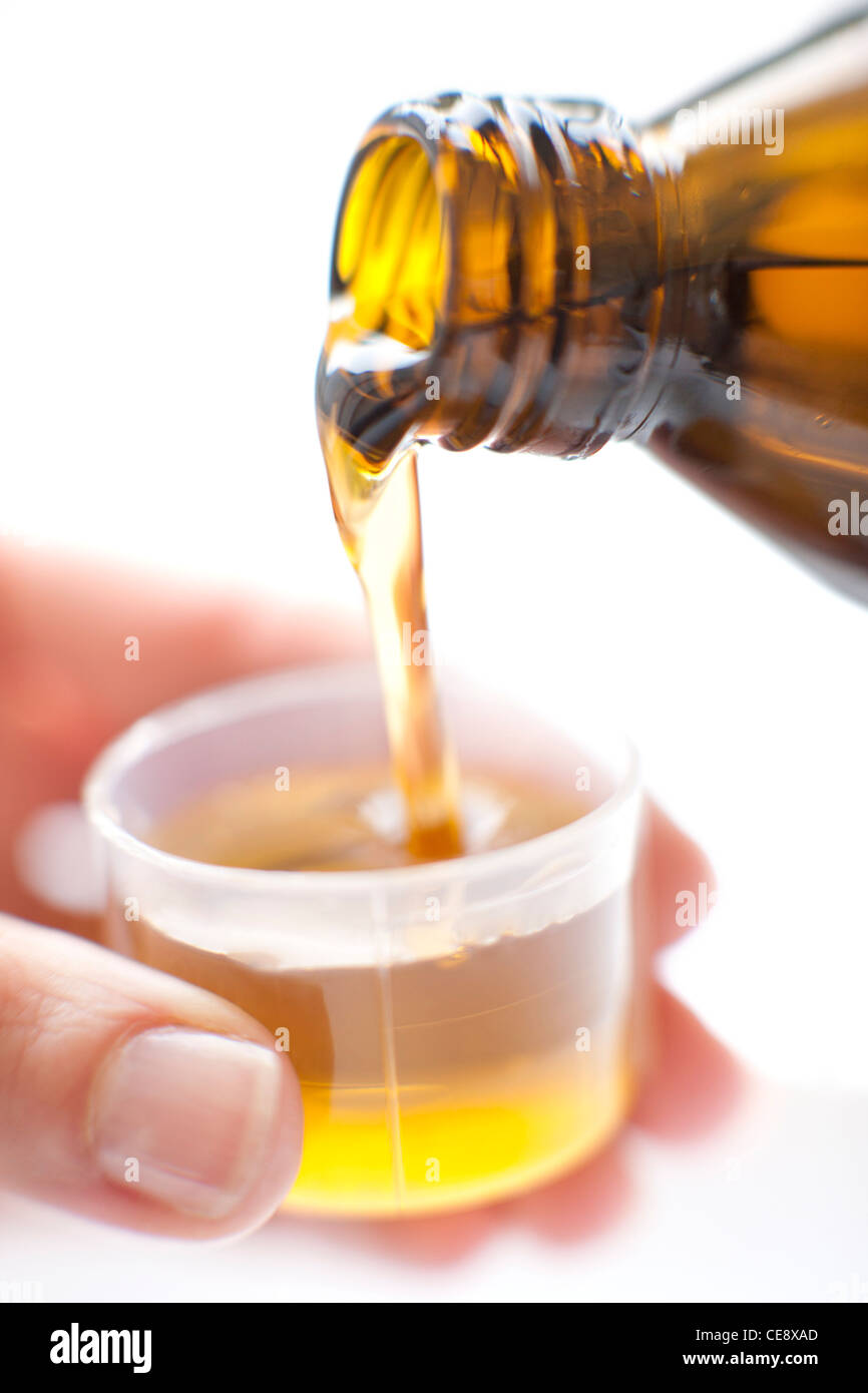 MODEL RELEASED. Pouring medicine Stock Photo - Alamy