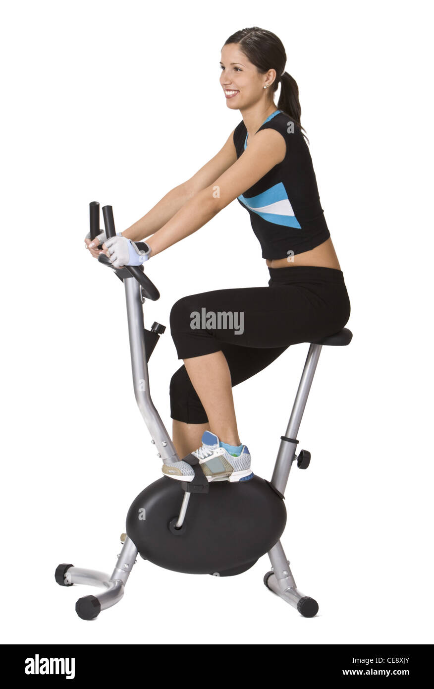 Girl riding a fitness bicycle against a white background Stock Photo ...