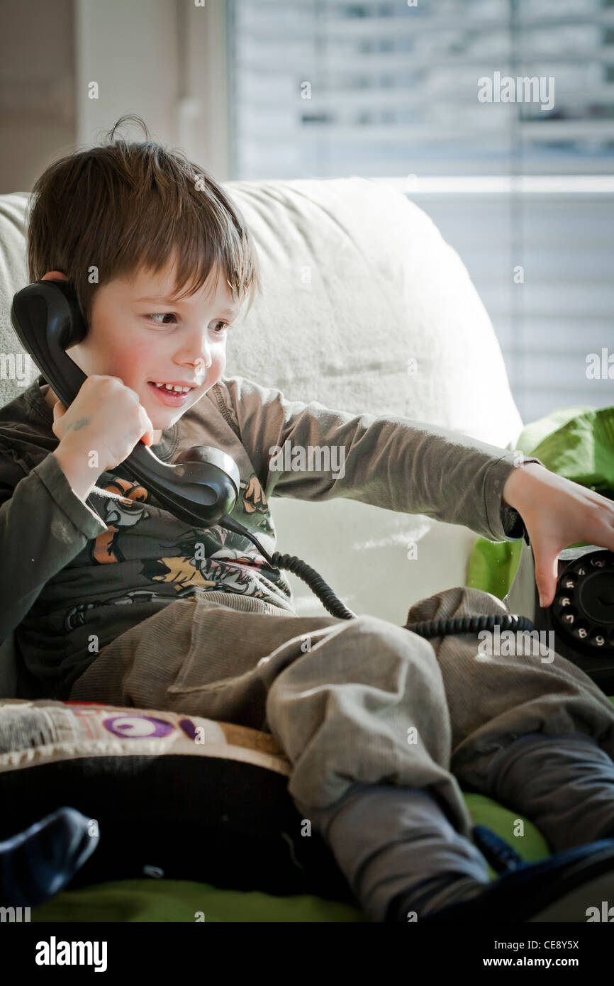 Boy using a retro telephone Stock Photo - Alamy