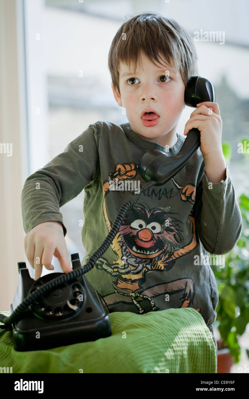 Boy using a retro telephone Stock Photo - Alamy