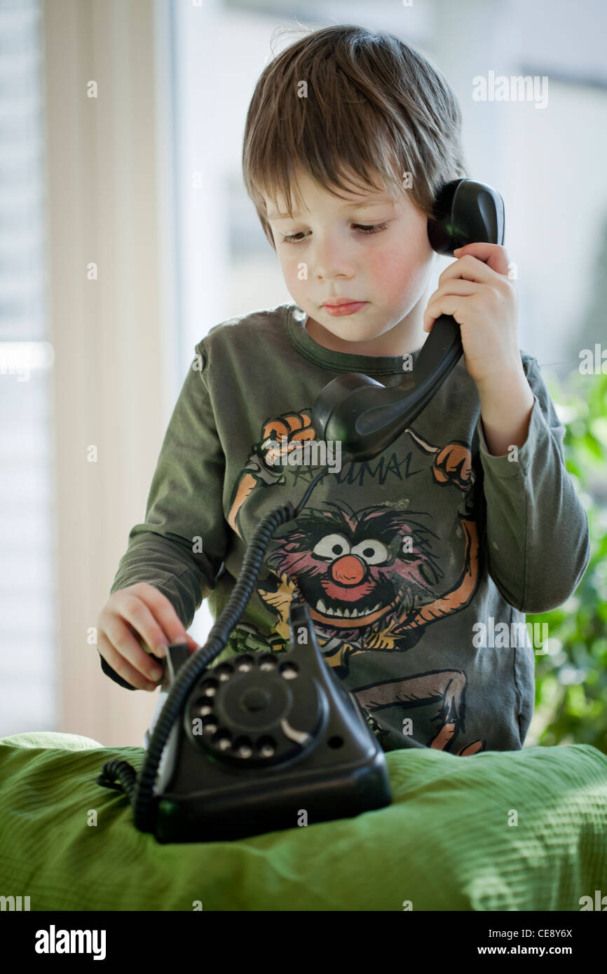 Boy using a retro telephone Stock Photo - Alamy