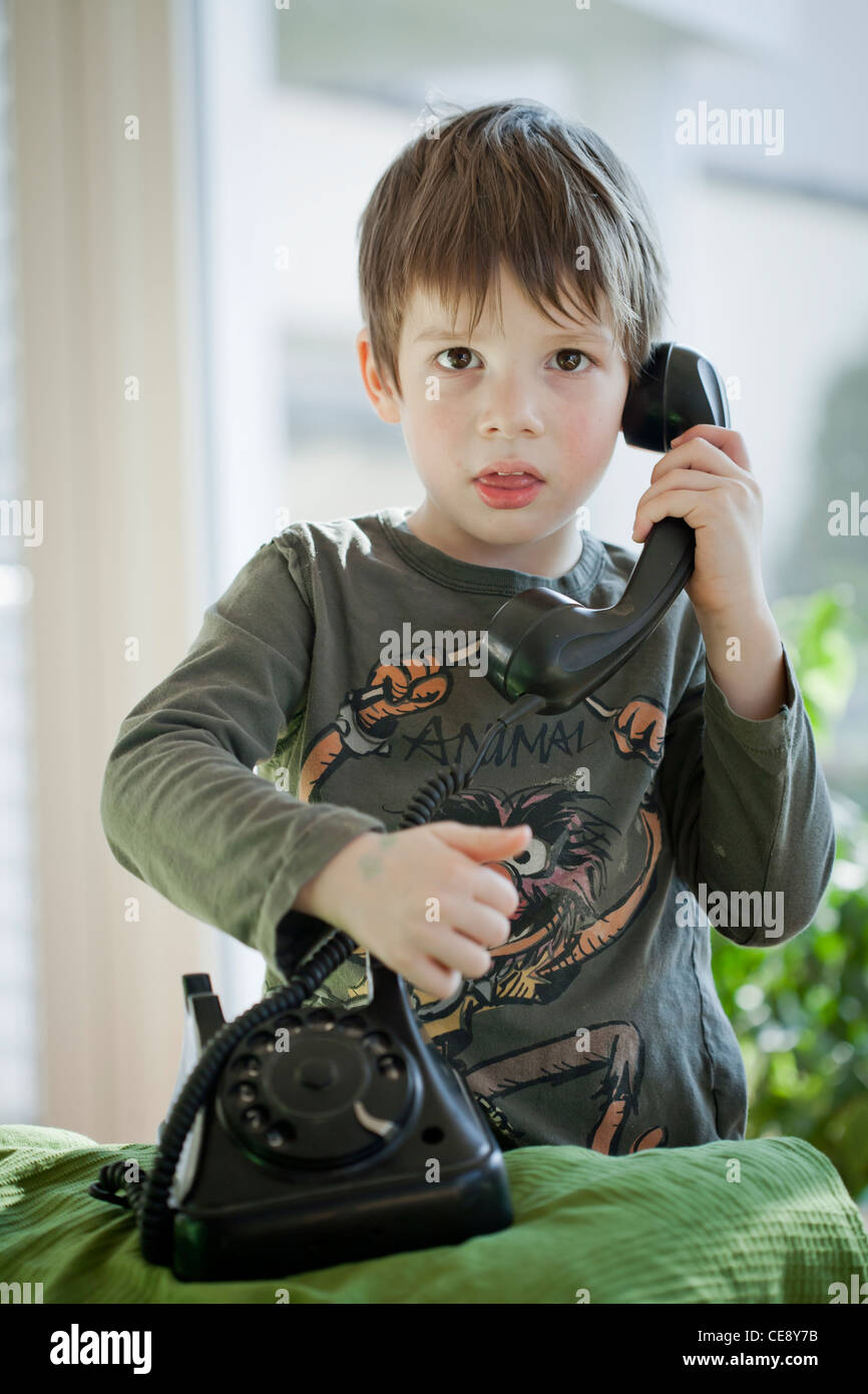 Boy using a retro telephone Stock Photo - Alamy