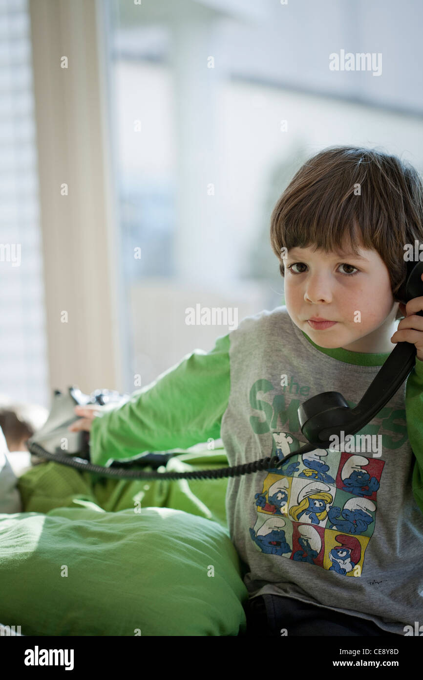 Boy using a retro telephone Stock Photo - Alamy