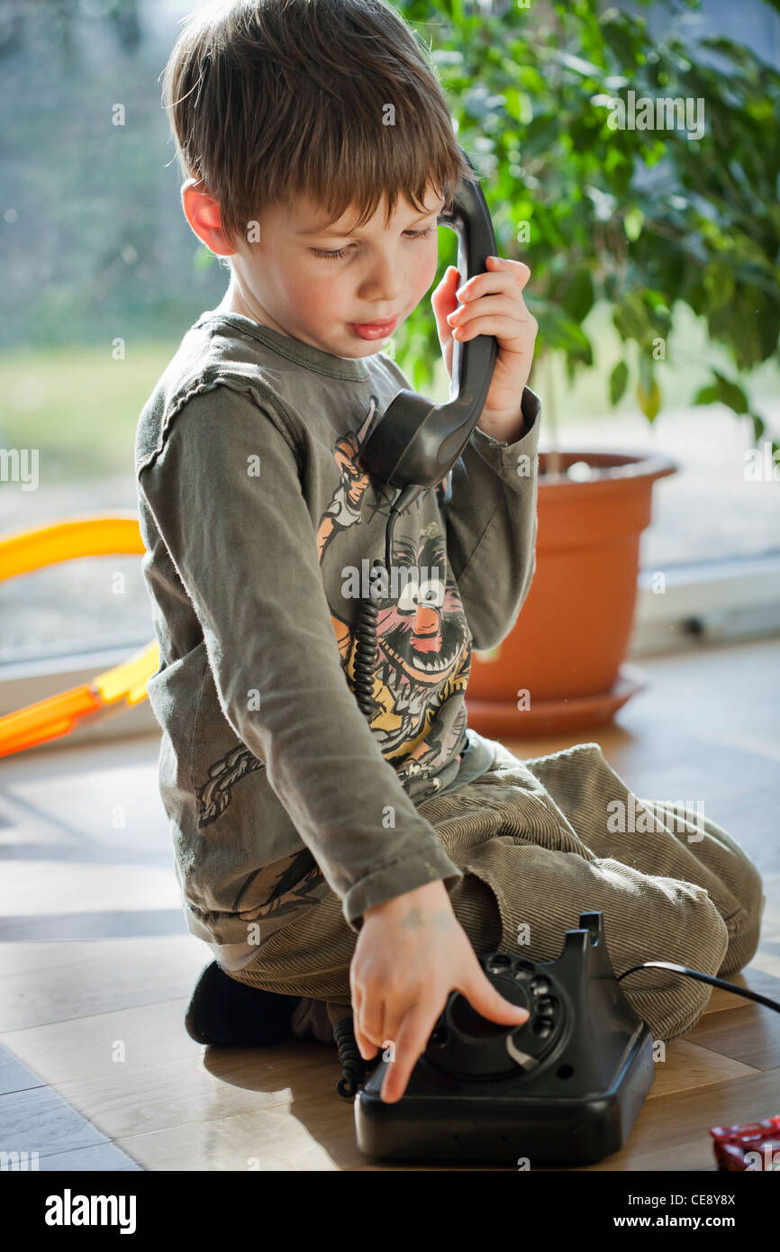 Boy using a retro telephone Stock Photo - Alamy