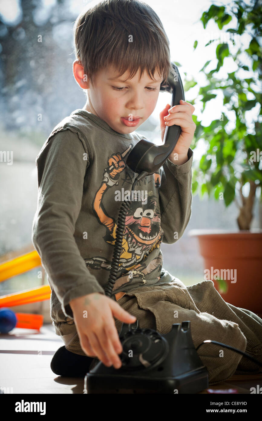 Boy using a retro telephone Stock Photo - Alamy