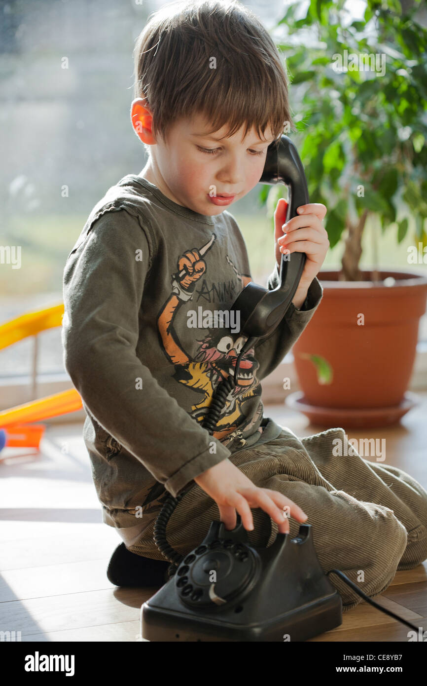 Boy using a retro telephone Stock Photo - Alamy