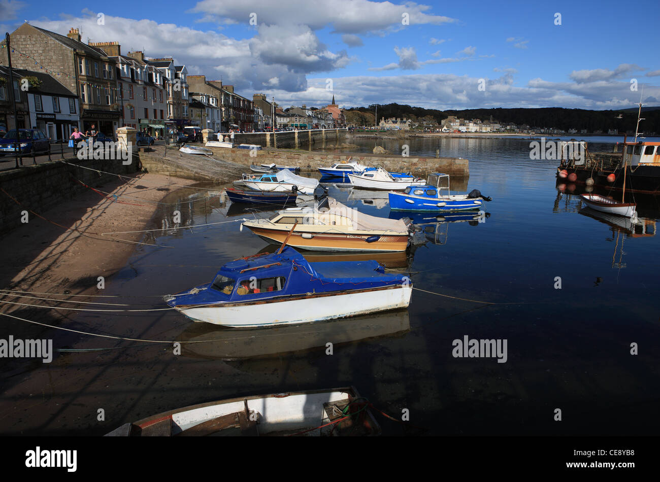 Boats in the harbour in front of the main street in Millport on the ...