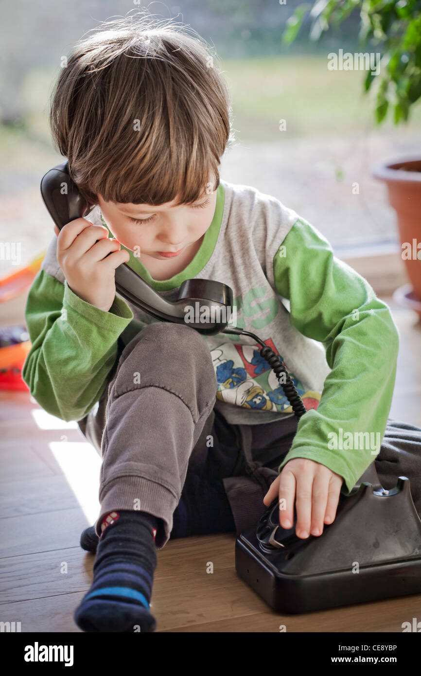 Boy using a retro telephone Stock Photo - Alamy