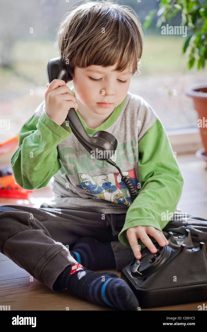 Boy using a retro telephone Stock Photo - Alamy