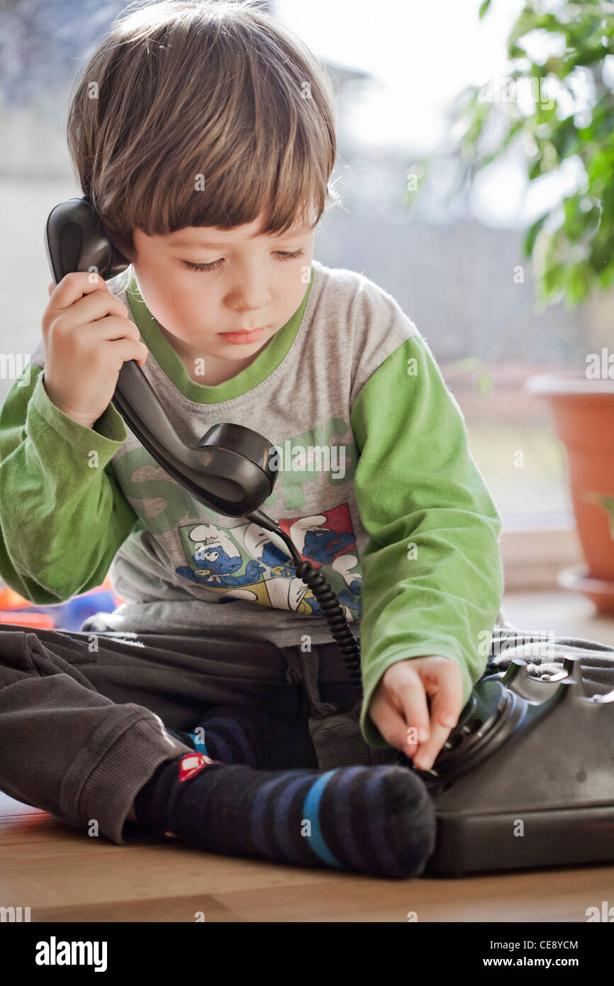 Boy using a retro telephone Stock Photo - Alamy