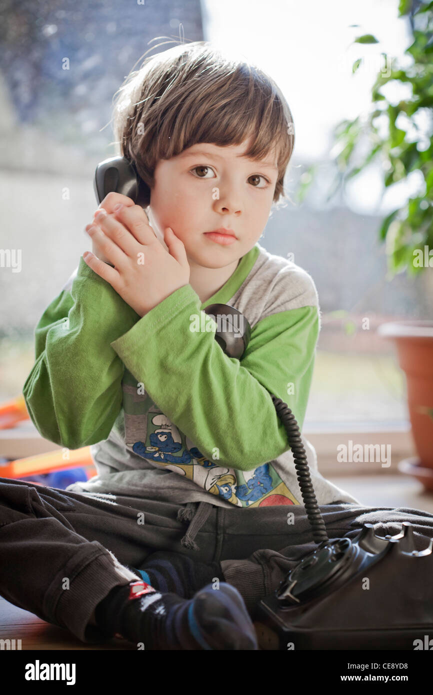 Boy using a retro telephone Stock Photo - Alamy