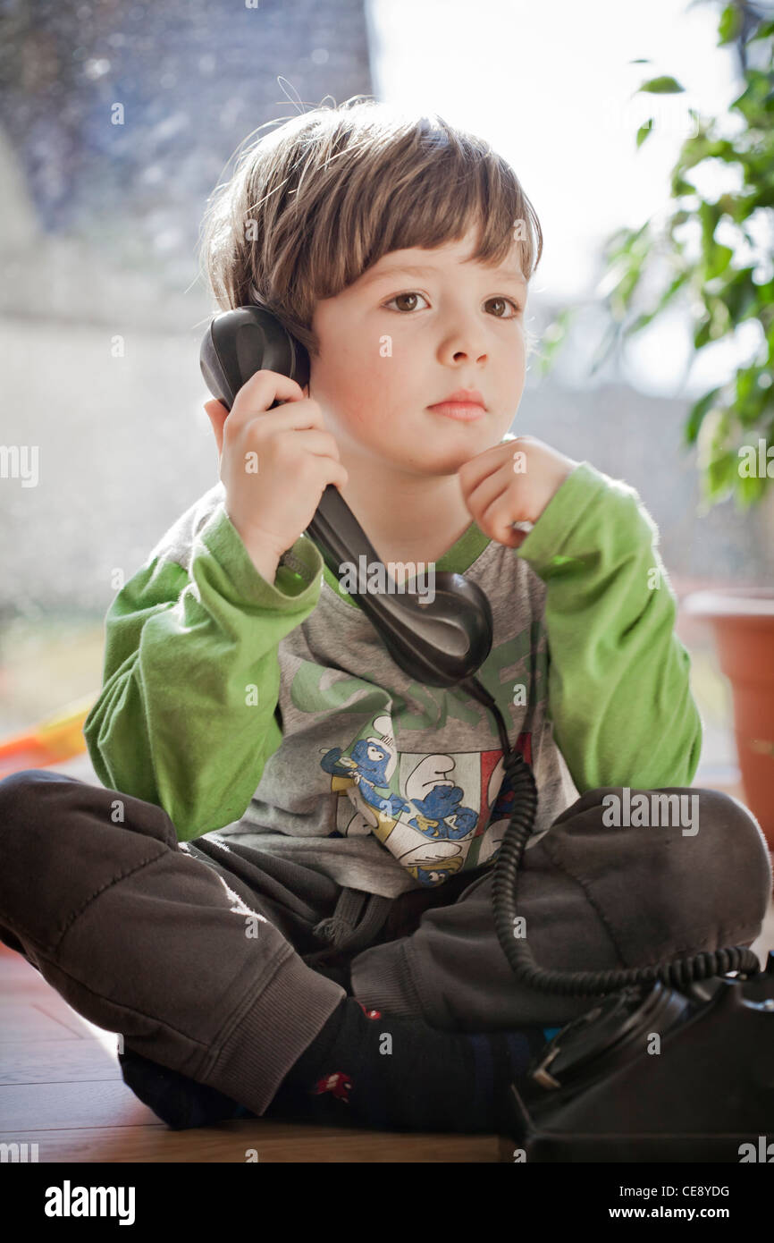Boy using a retro telephone Stock Photo - Alamy