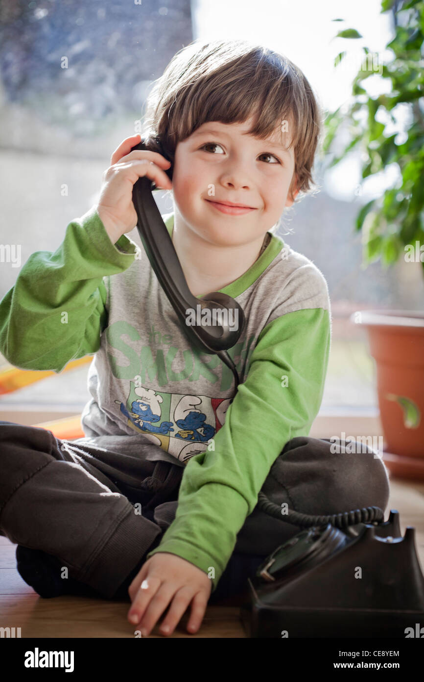 Boy using a retro telephone Stock Photo - Alamy