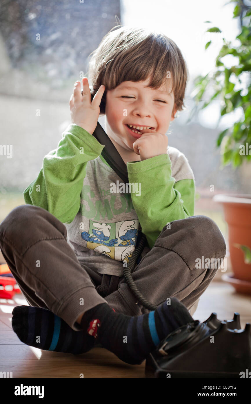 Boy using a retro telephone Stock Photo - Alamy