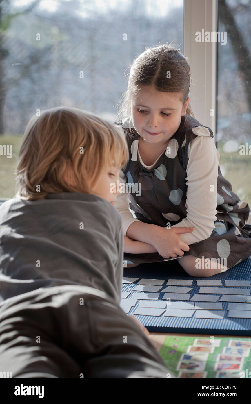 Two friends playing memory card Stock Photo - Alamy