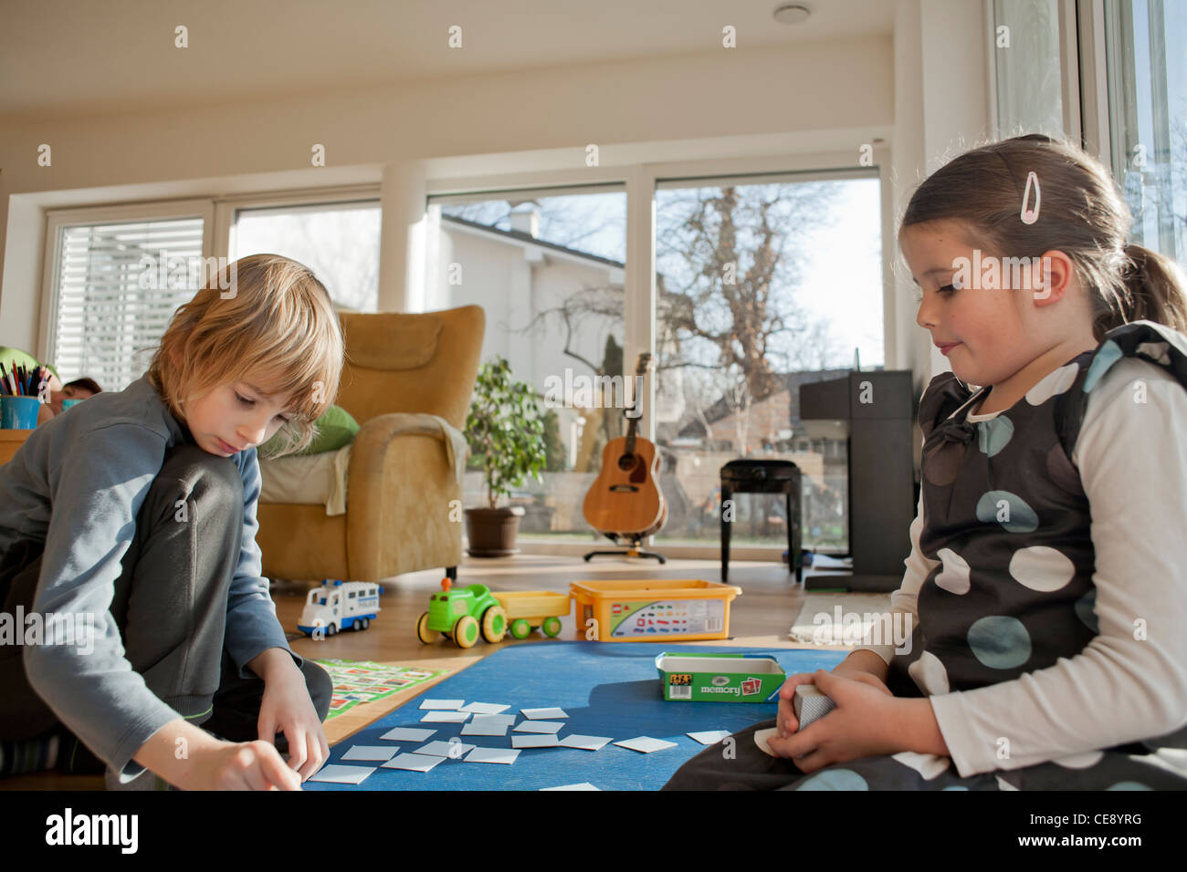 Two friends playing memory card game on the floor Stock Photo - Alamy