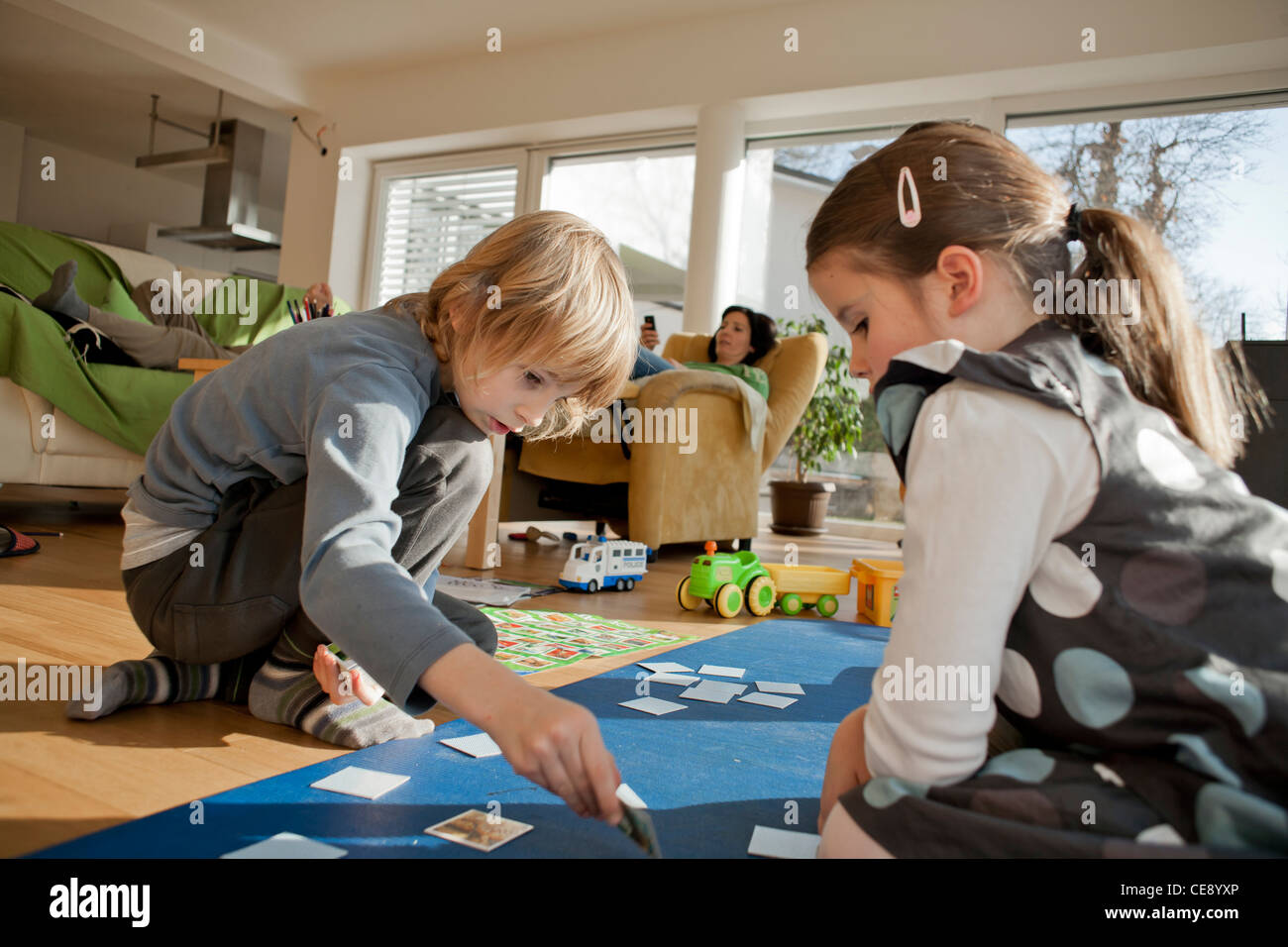Two friends playing memory card game on the floor Stock Photo - Alamy