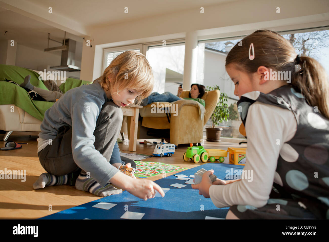 Two friends playing memory card game on the floor Stock Photo - Alamy