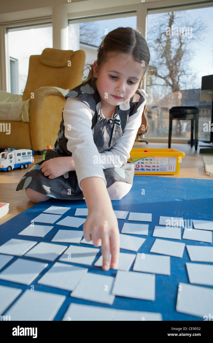 Young girls playing memory card game on the floor Stock Photo - Alamy