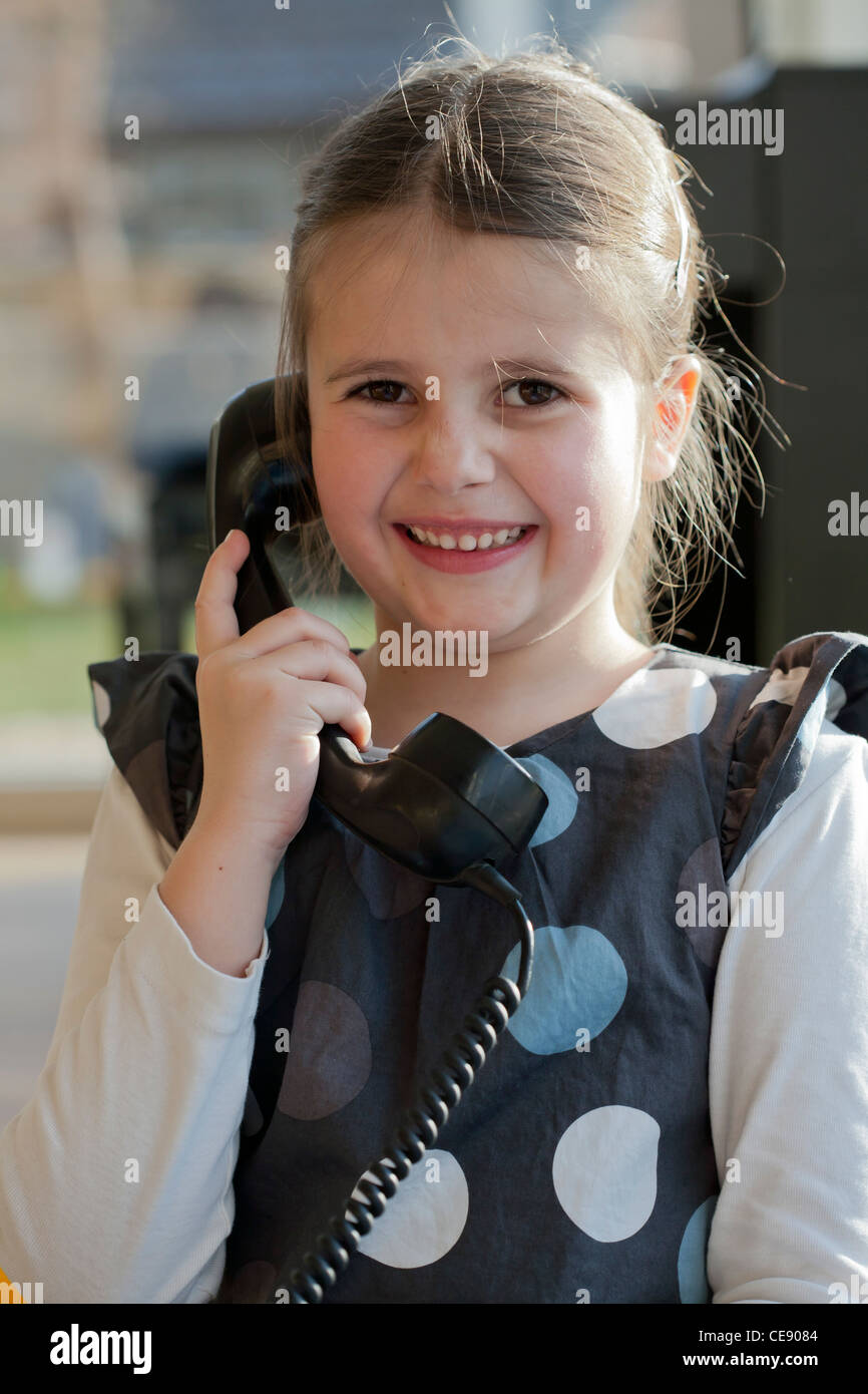 Girl using a retro telephone Stock Photo - Alamy