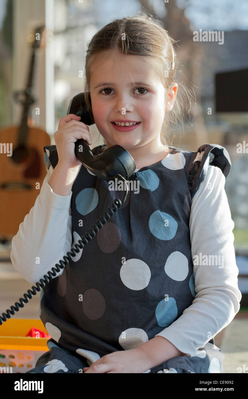 Girl using a retro telephone Stock Photo - Alamy
