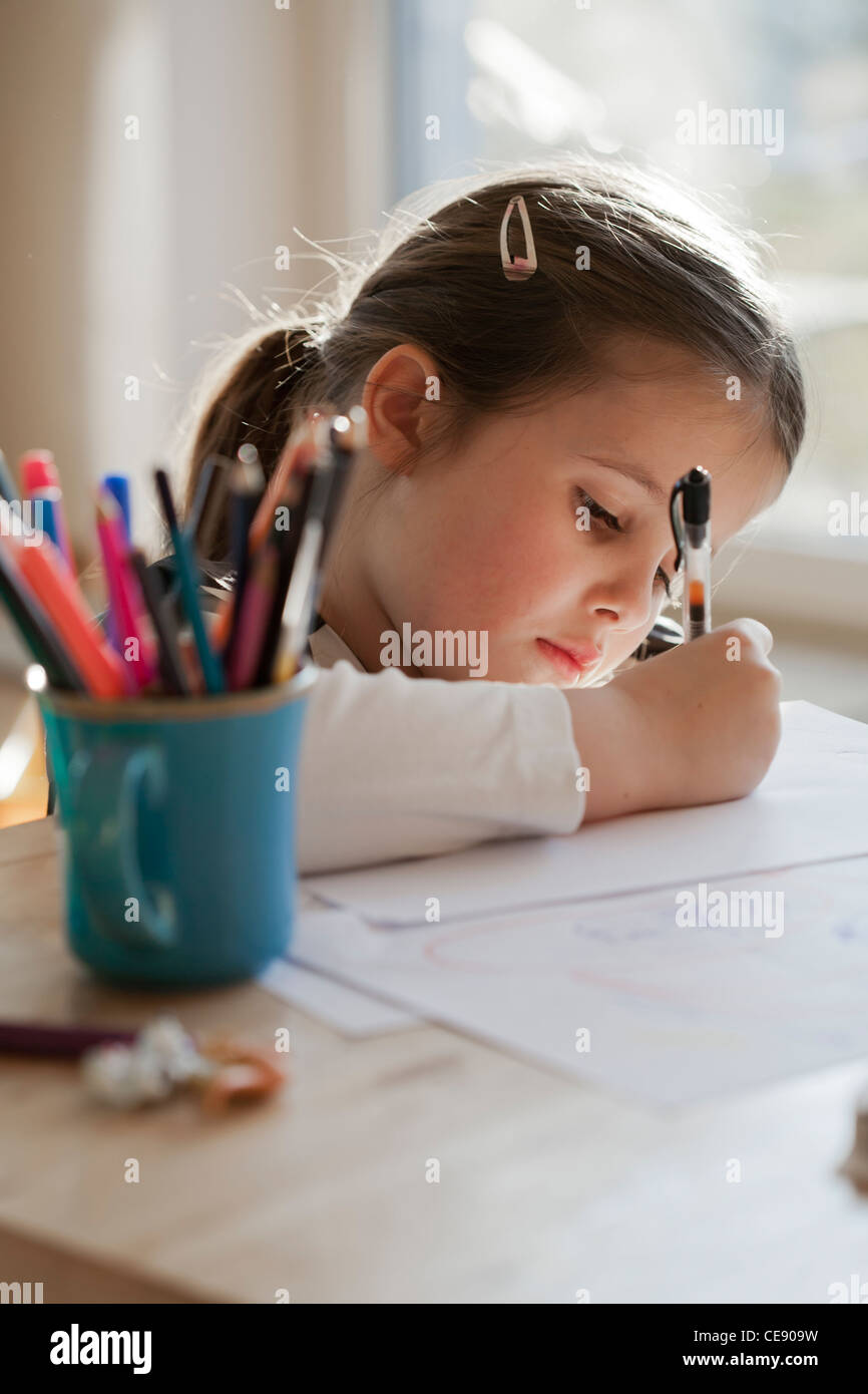 Girl drawing on paper Stock Photo - Alamy