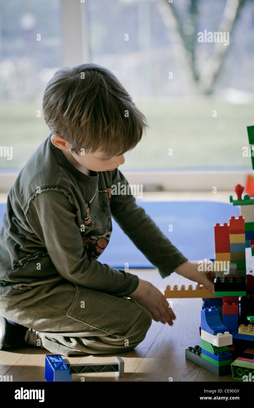 Boy playing indoor Stock Photo - Alamy