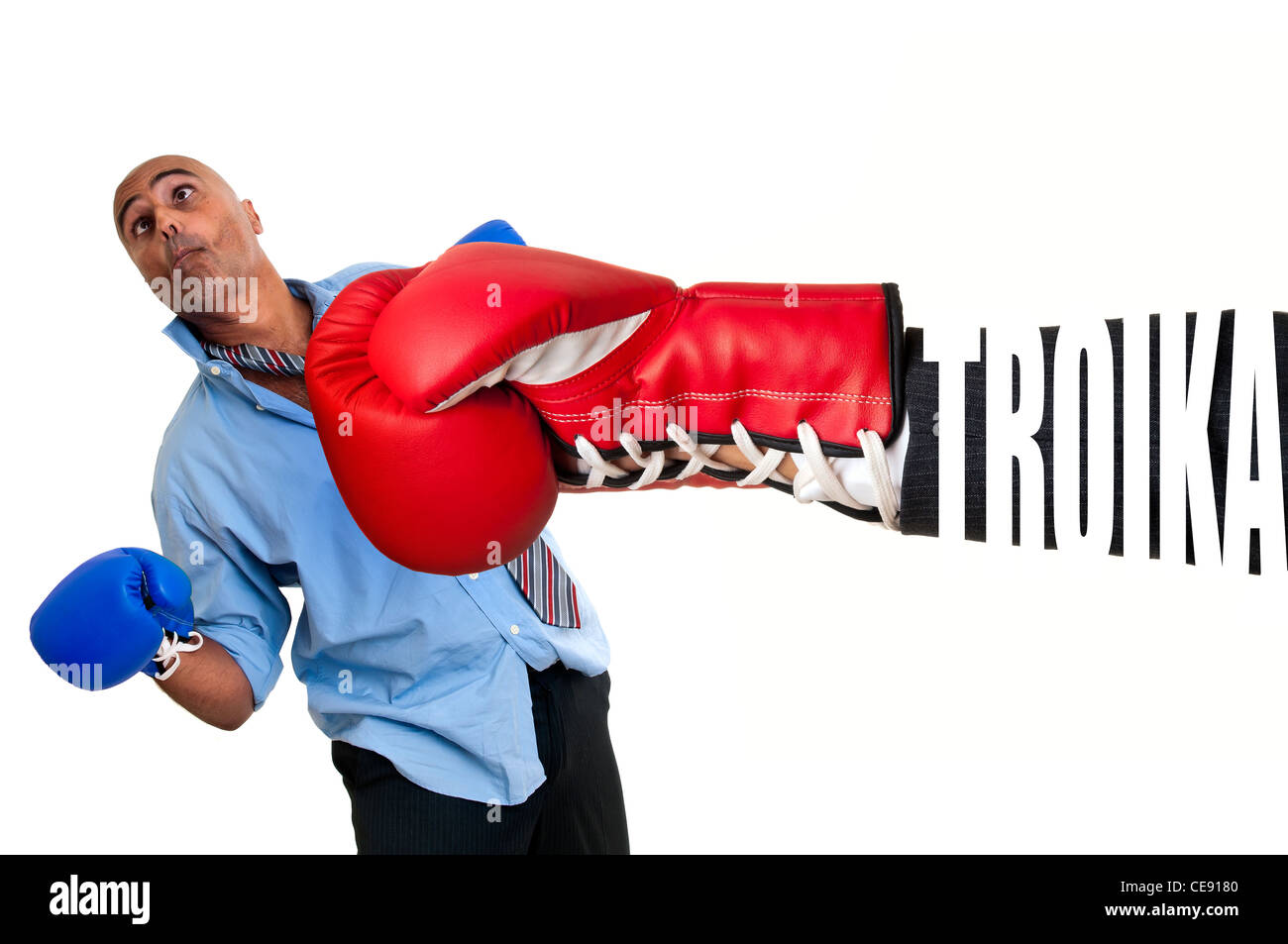 Businessman taking a hit by the Troika's hand Stock Photo - Alamy