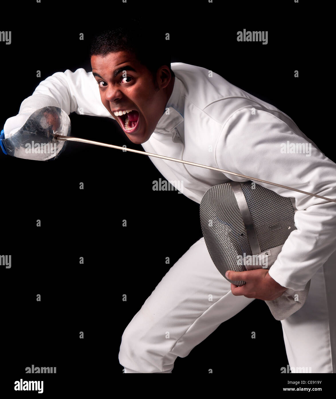 Male fencer isolated in a dark background Stock Photo - Alamy