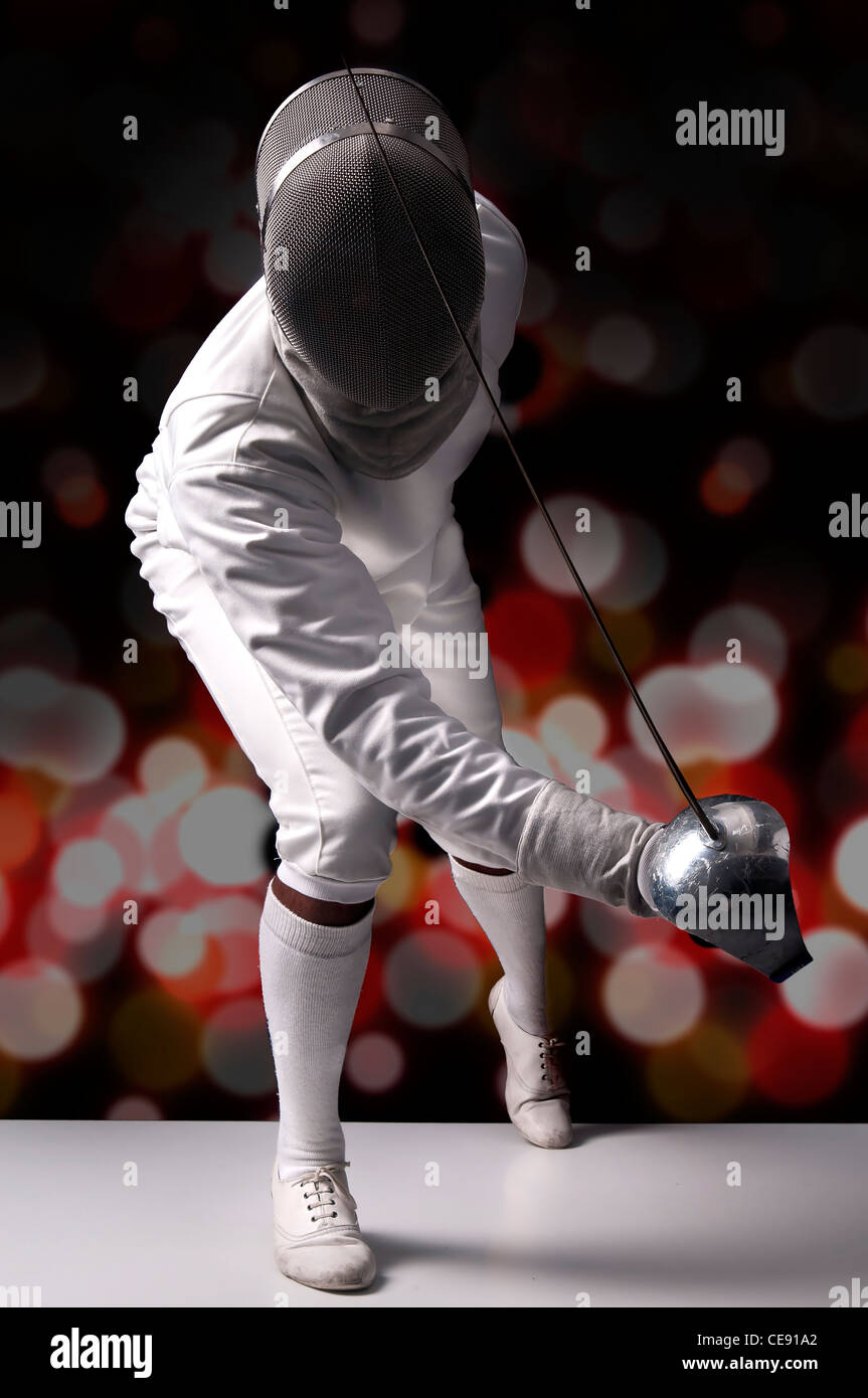 Male fencer isolated in a dark background Stock Photo - Alamy