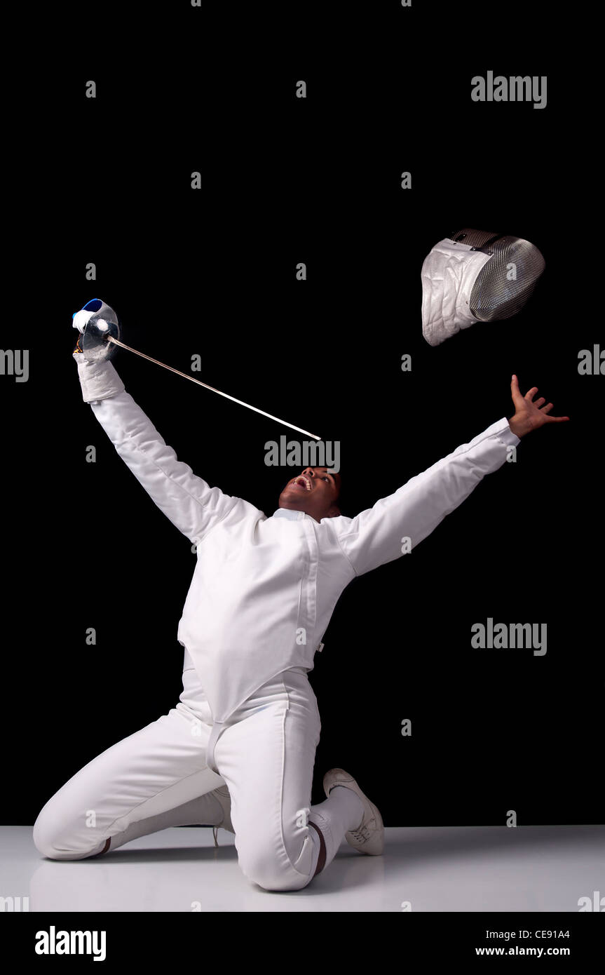 Male fencer isolated in a dark background Stock Photo - Alamy