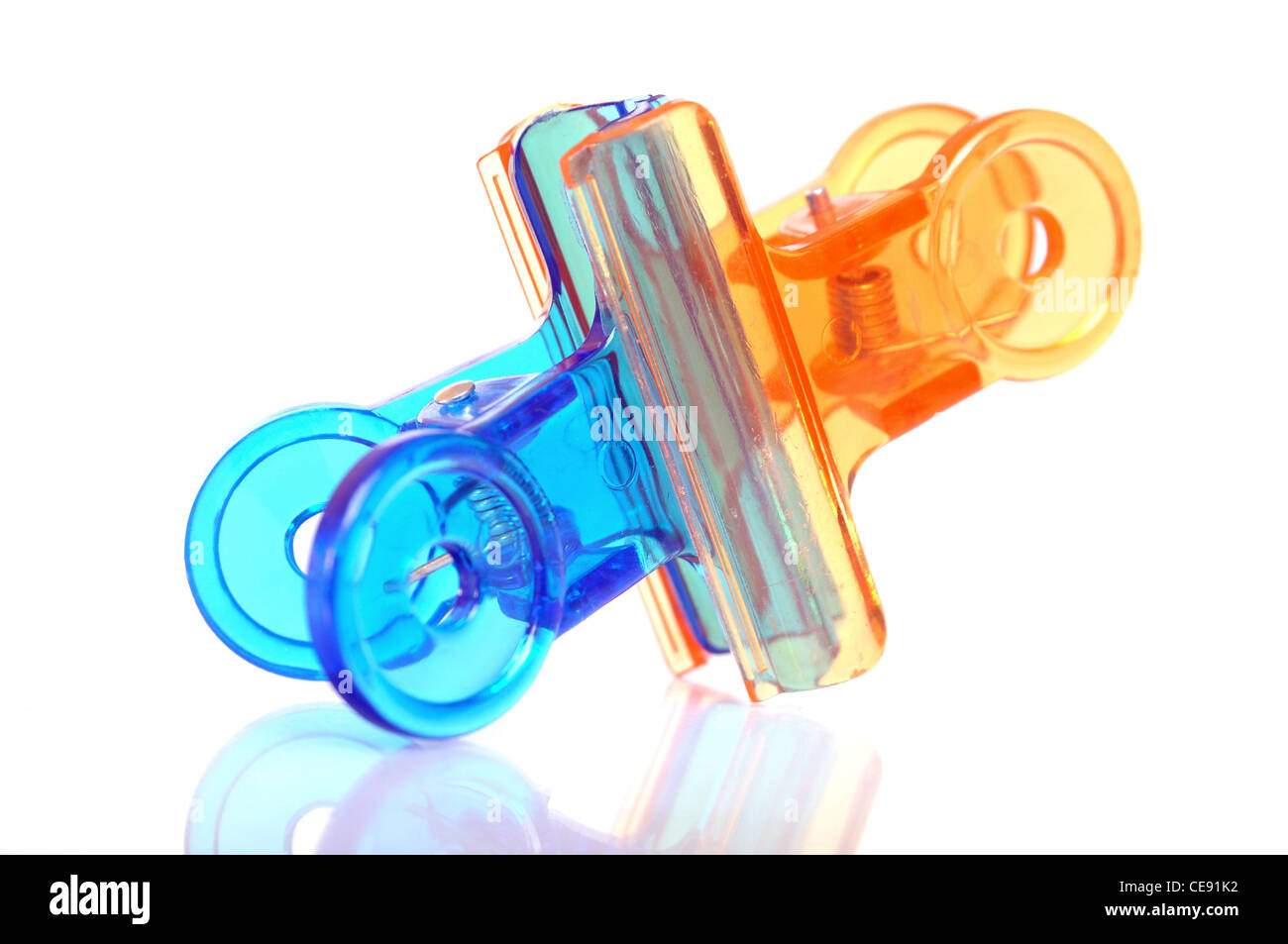 Blue and orange colored office paper clips on white background Stock ...